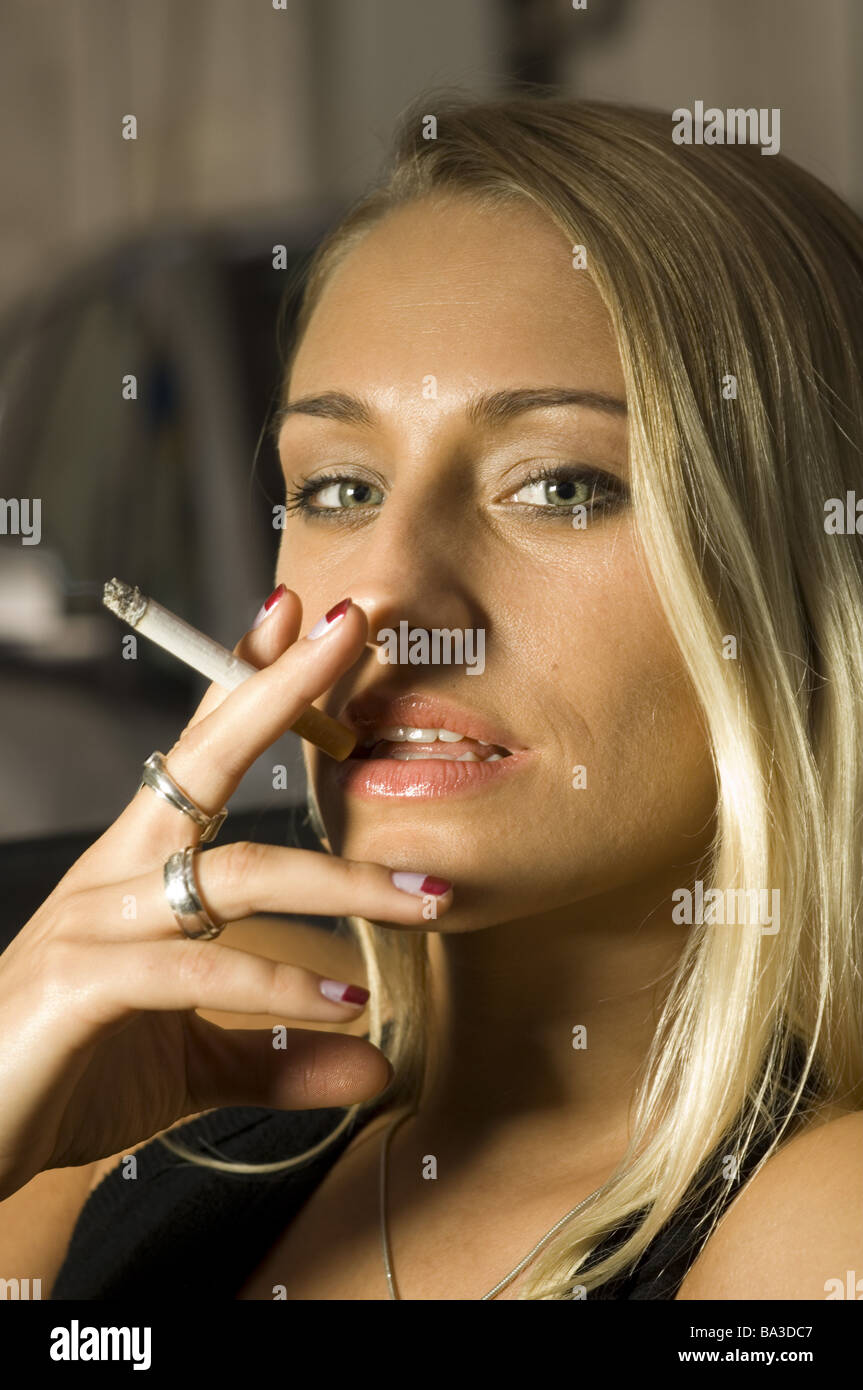 Relaxed young woman sitting smoking hi-res stock photography and images ...