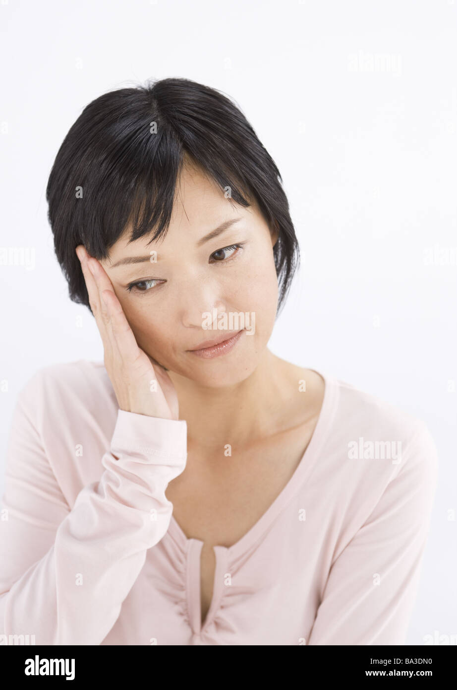 A woman touching her temple Stock Photo - Alamy