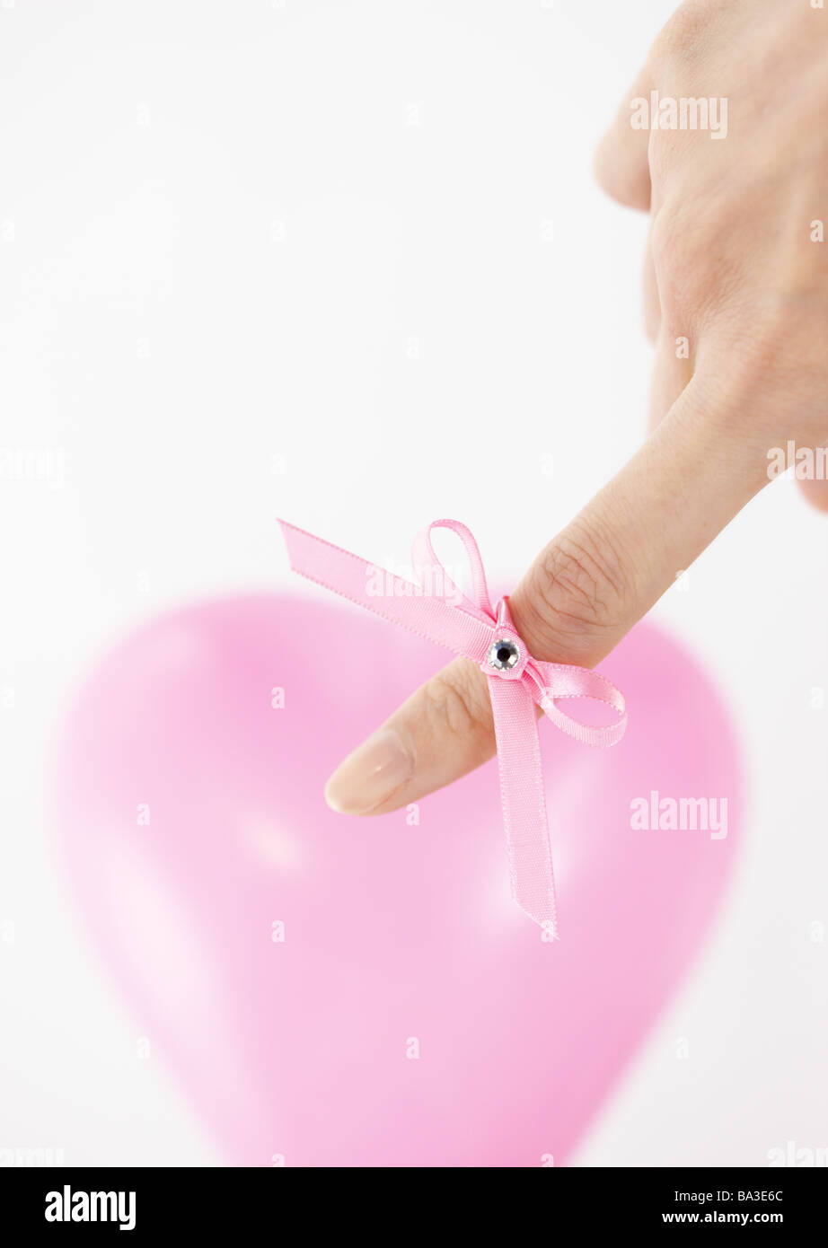 Finger tied with ribbon Stock Photo - Alamy