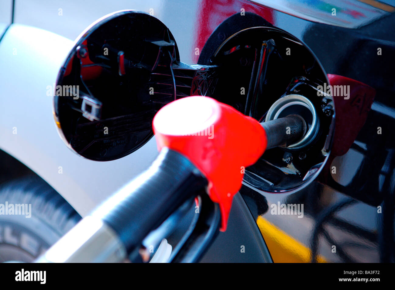 Pumping gas into car fueling gas Stock Photo - Alamy