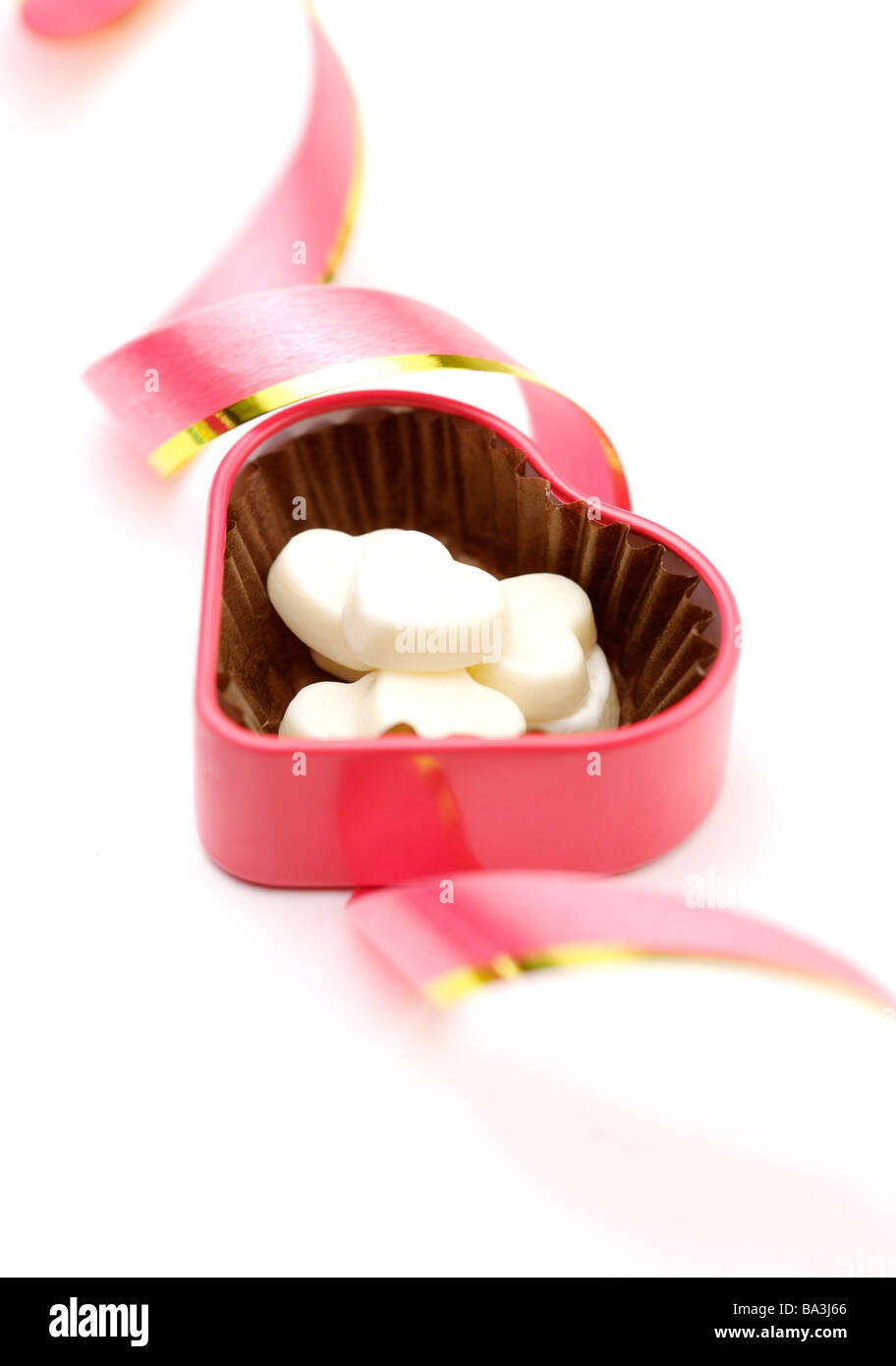 Heart shape candy in heart shape box with ribbon Stock Photo - Alamy