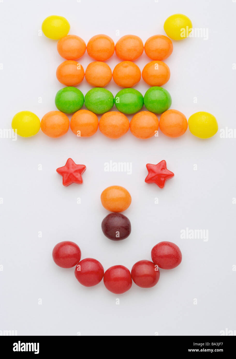 Candy laid out to make head of man and hat Stock Photo - Alamy