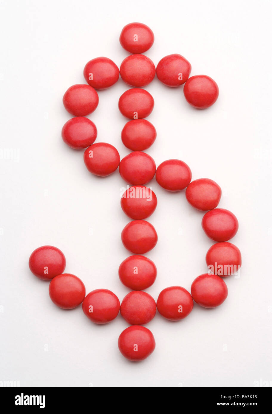 Candy laid out to make sign of dollar sign Stock Photo - Alamy