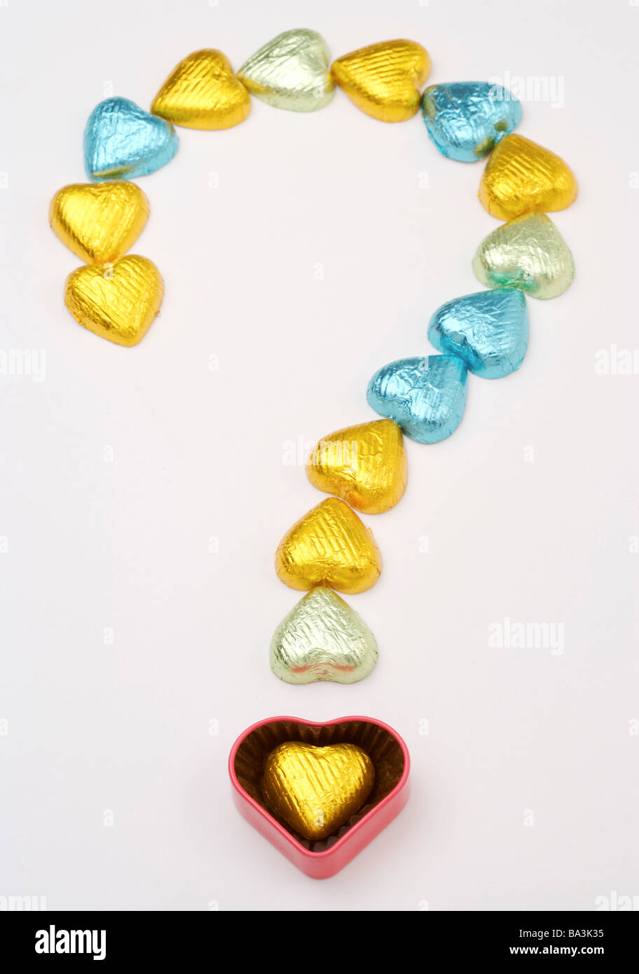 Heart shape chocolate laid out to make sign of question mark Stock ...