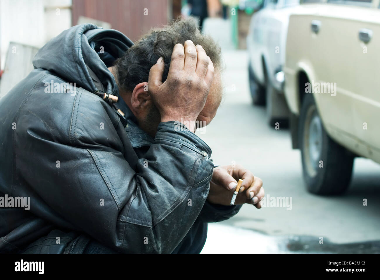 Despair of the homeless man Stock Photo - Alamy