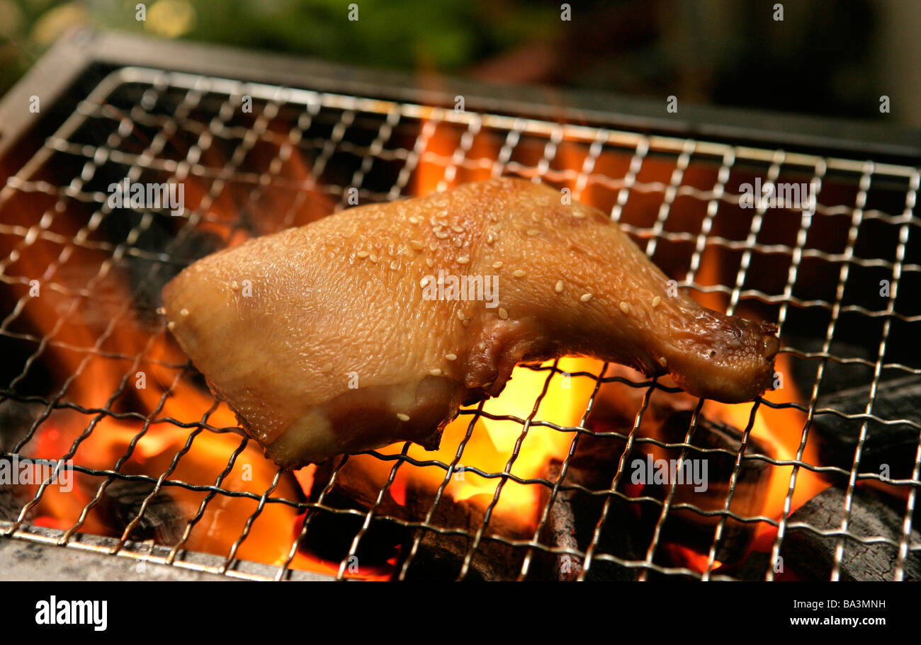 Chicken leg over charcoal fire Stock Photo - Alamy