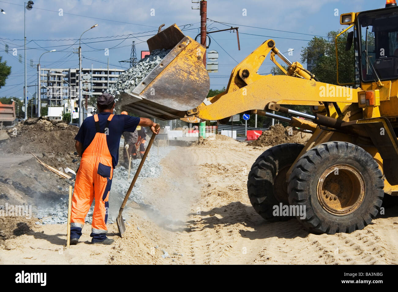 Worker and road loader Stock Photo - Alamy