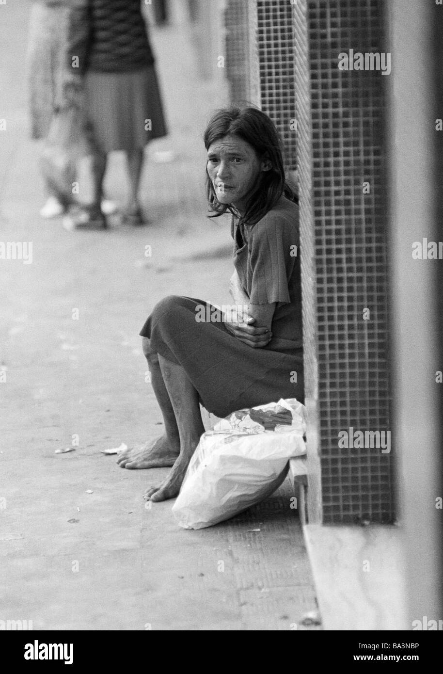 Seventies, black and white photo, people, poorness, beggar-woman sits ...