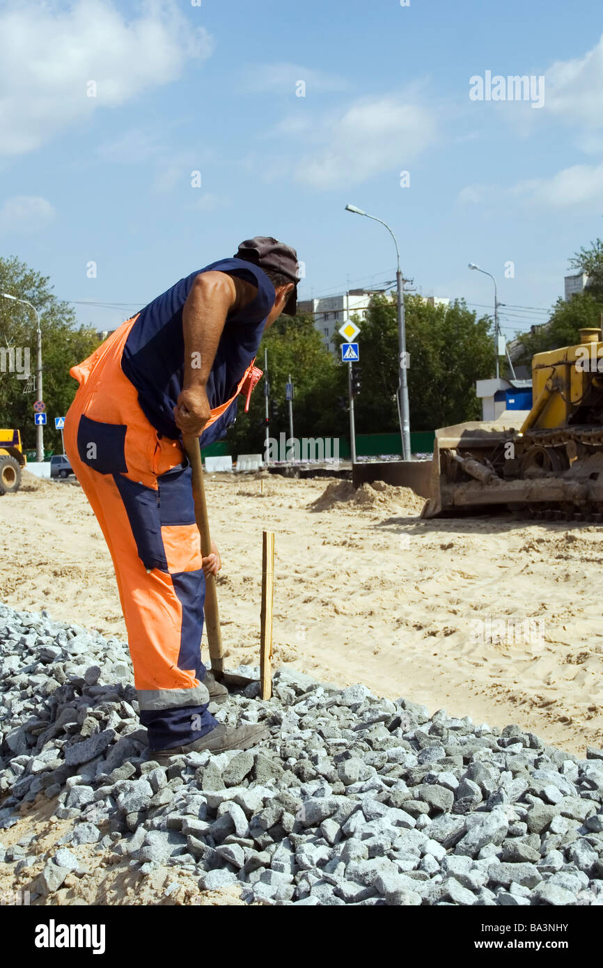 Worker with shovel Stock Photo - Alamy