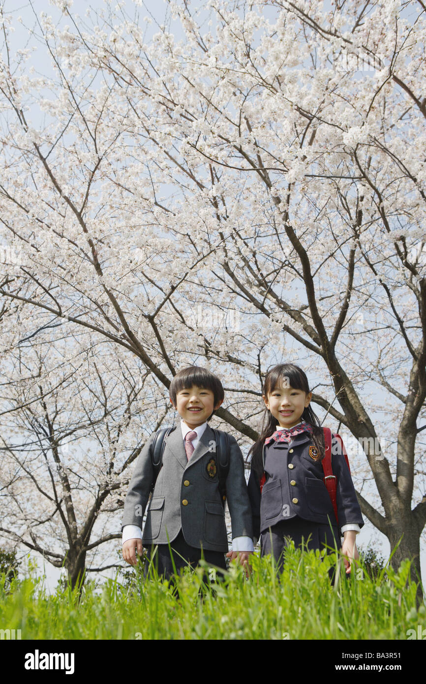 Schoolmate going to school and looking at camera Stock Photo - Alamy