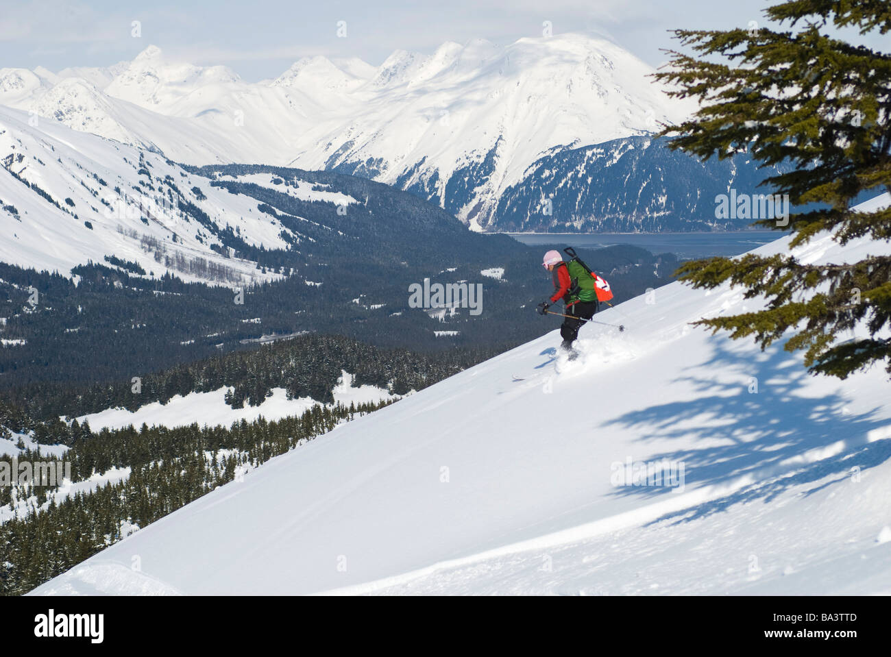 Woman skis downhill on Tincan Ridge in the Turnagain Pass area of ...