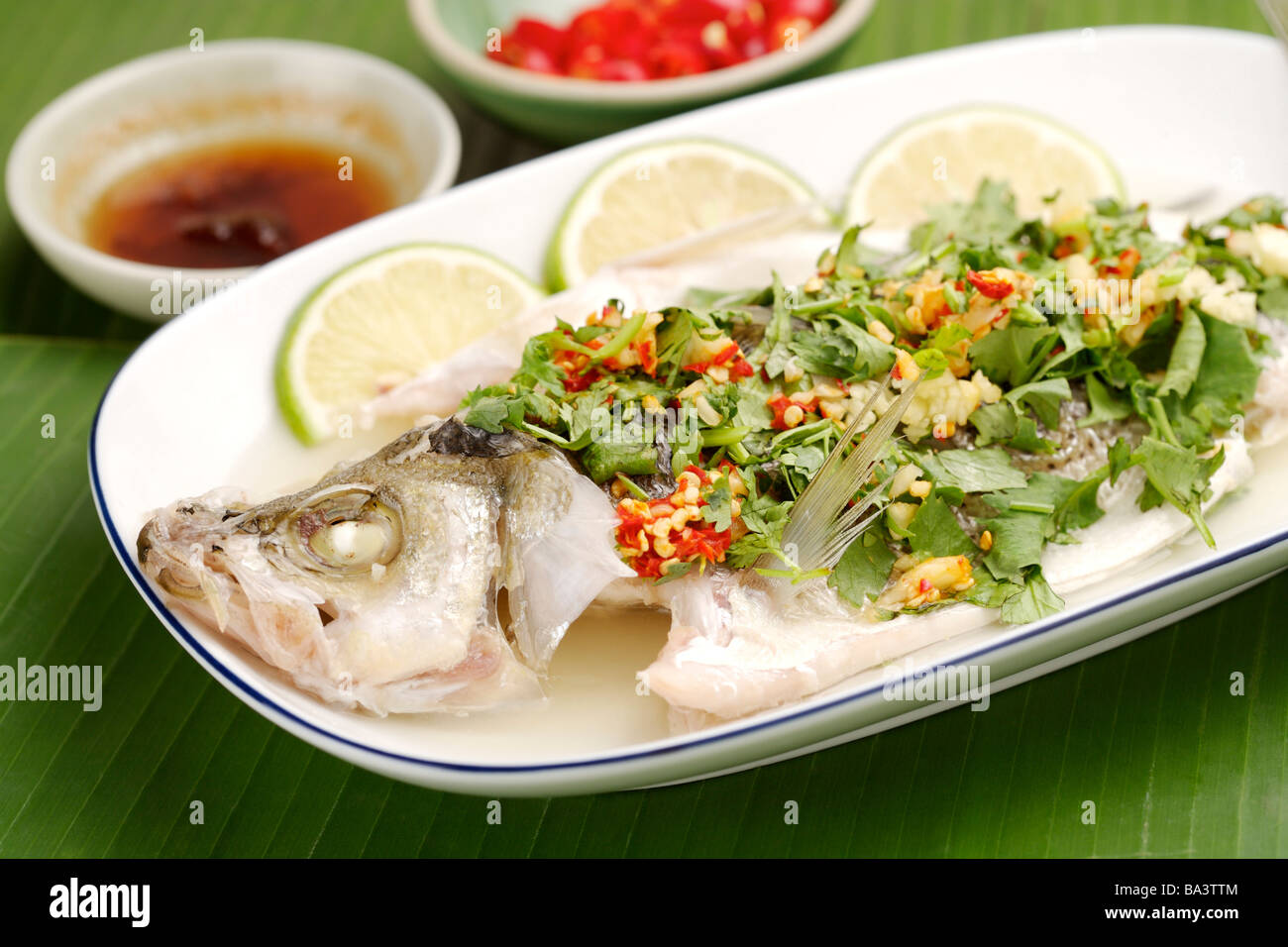 Steamed Fish With Lemon Sauce Stock Photo - Alamy