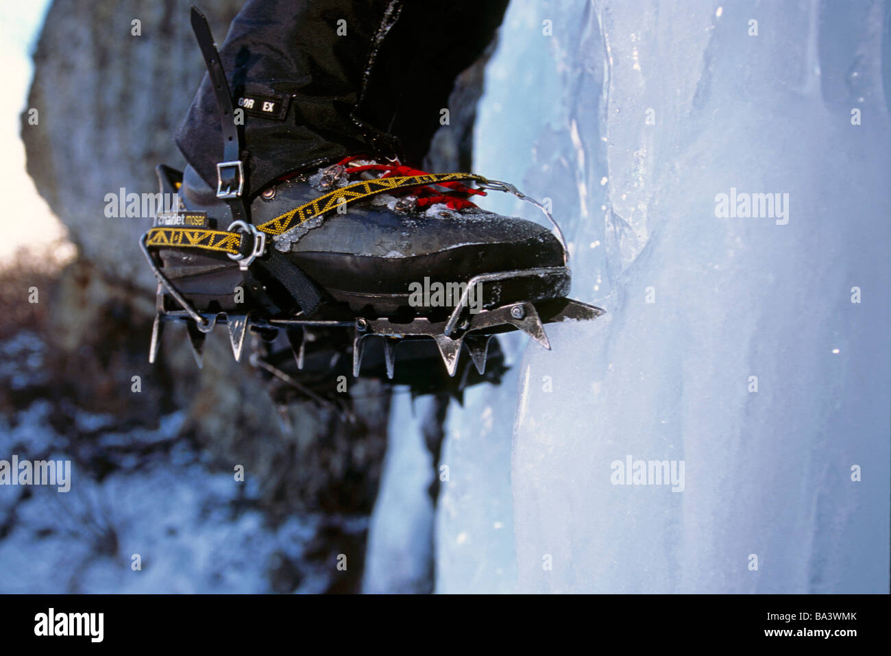 Closeup of Ice climbers boot w/crampon in ice on frozen waterfall ...