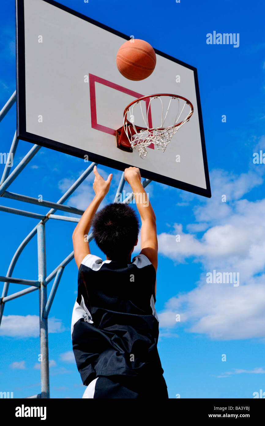 Teenage boy shooting basketball hi-res stock photography and images - Alamy