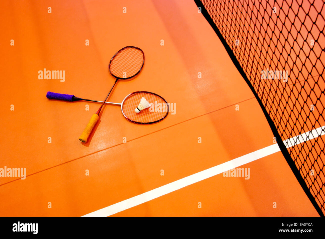 Badminton rackets and shuttlecock on badminton court Stock Photo - Alamy