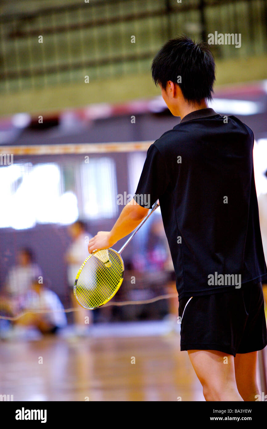 Three people playing badminton in court hi-res stock photography and ...