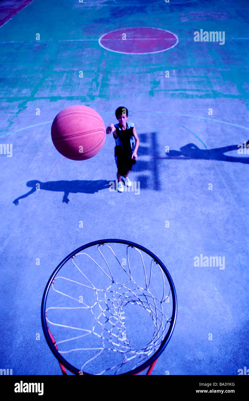 Teenage boy shooting a basketball Stock Photo - Alamy