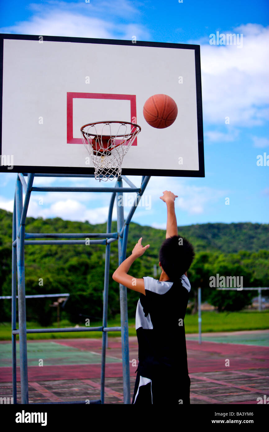 Teenage boy shooting a basketball Stock Photo - Alamy