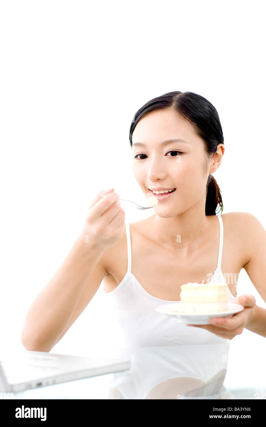 Young woman eating cake close up Stock Photo - Alamy