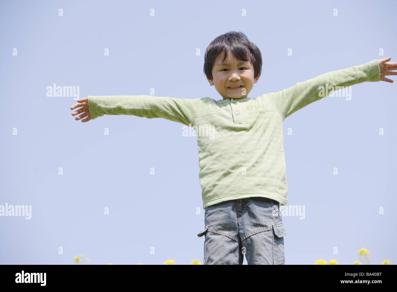 Japanese boy with arms outstretched Stock Photo - Alamy