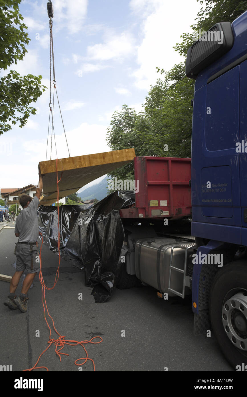 Street truck crane wood-bearers lifts man rope back-opinion secures ...