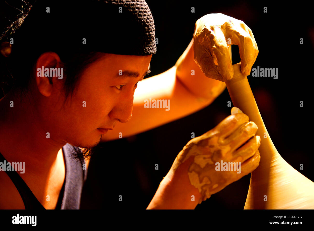 Potter molding clay body side view Stock Photo - Alamy