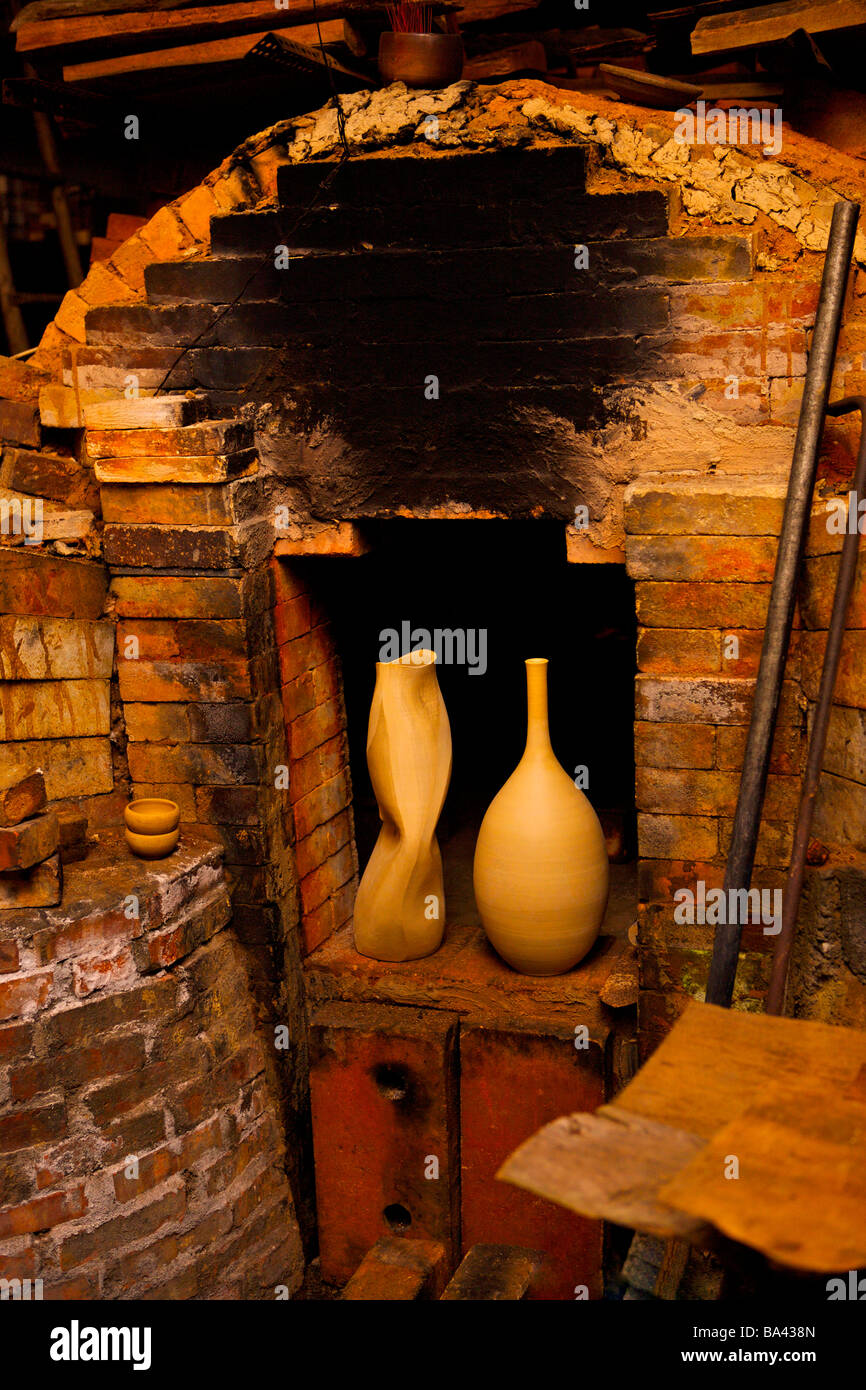 Two clay potteries placing in kiln s exit Stock Photo - Alamy