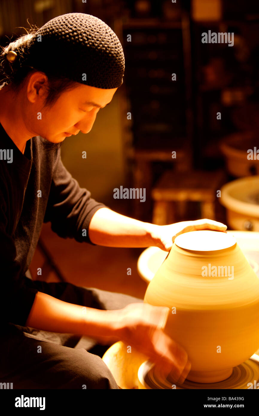 Potter Working on a Pottery Wheel side view Stock Photo - Alamy