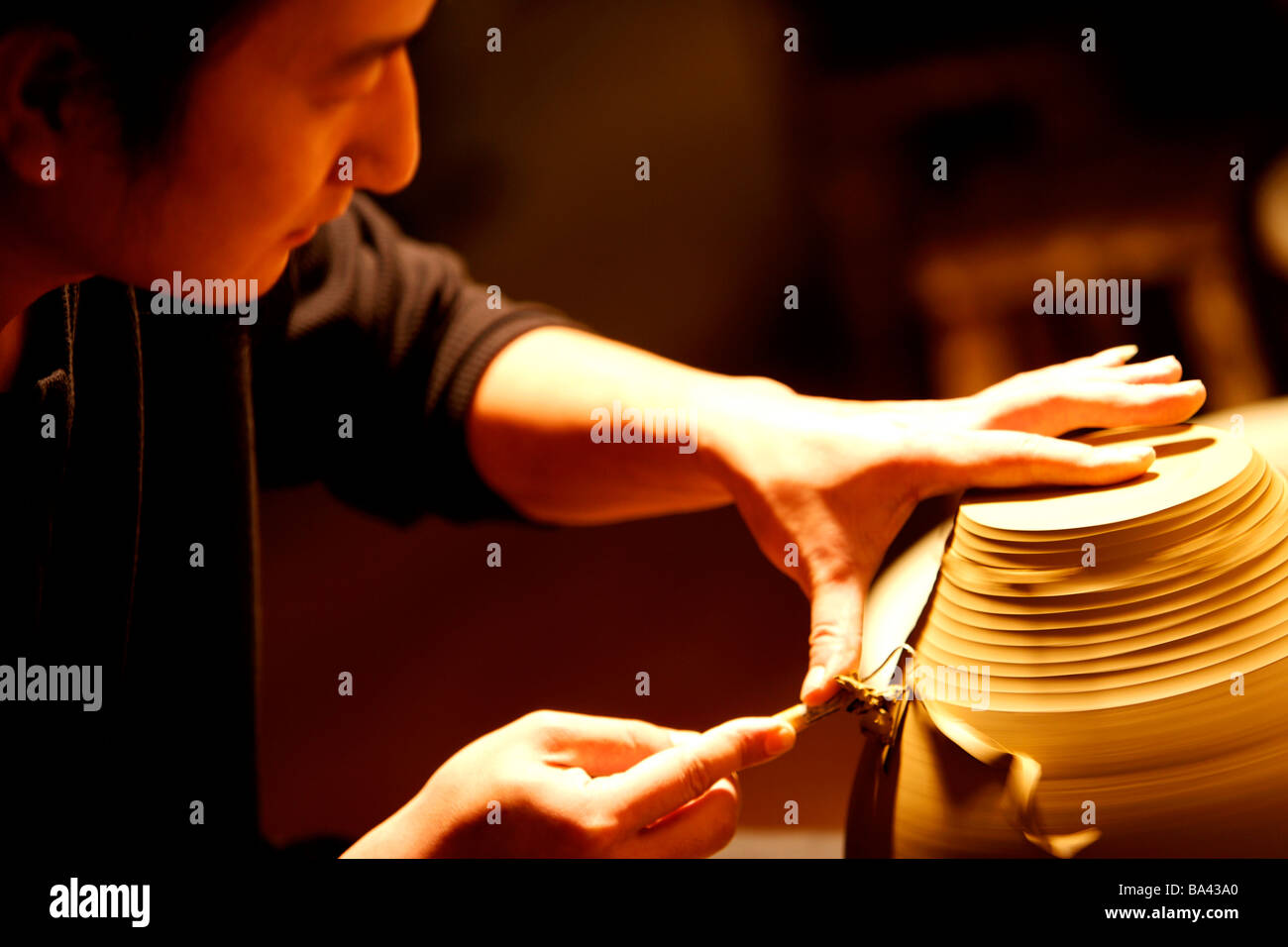 Potter trimming clay body Stock Photo - Alamy