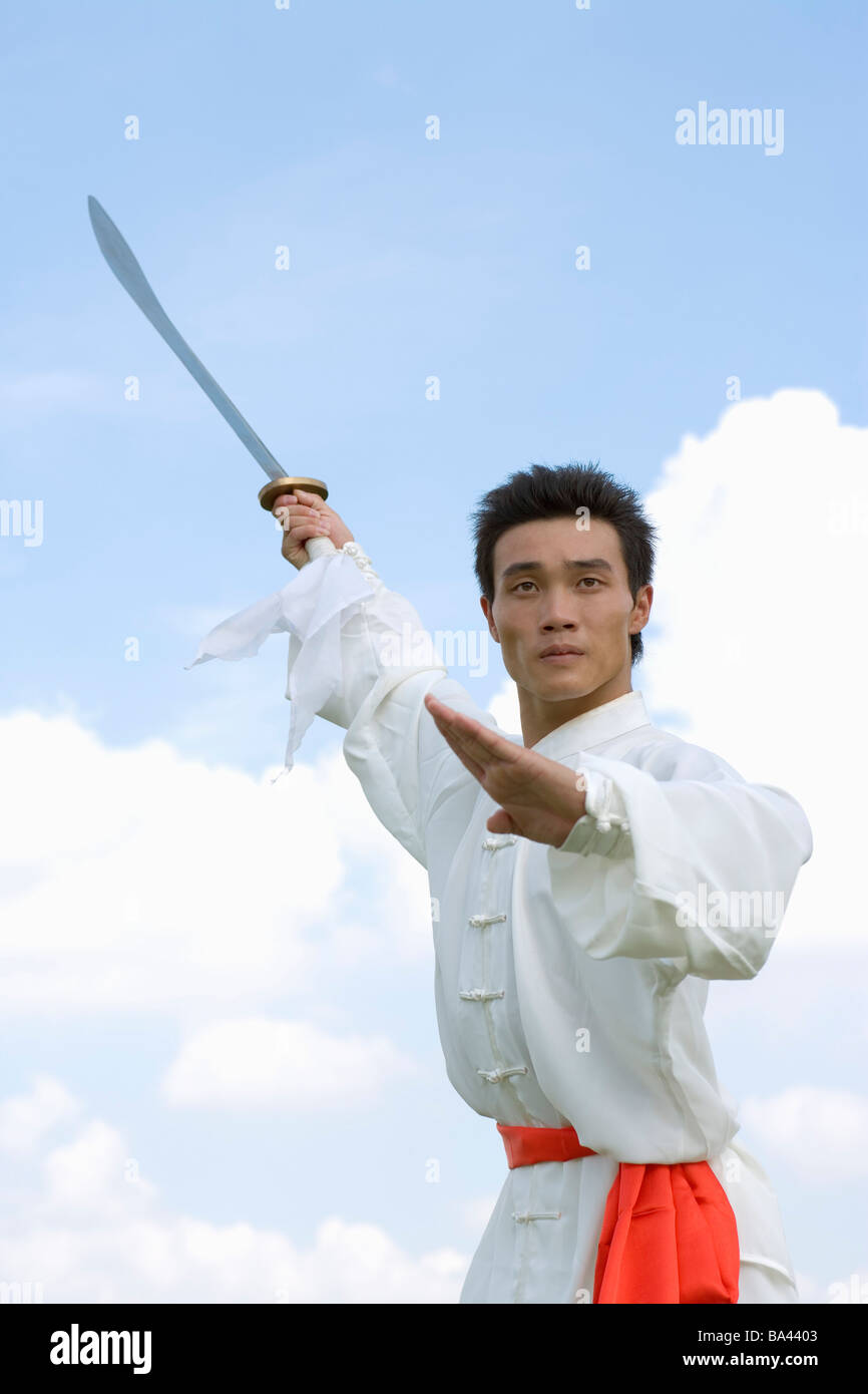 Man practicing martial arts with swords Stock Photo - Alamy