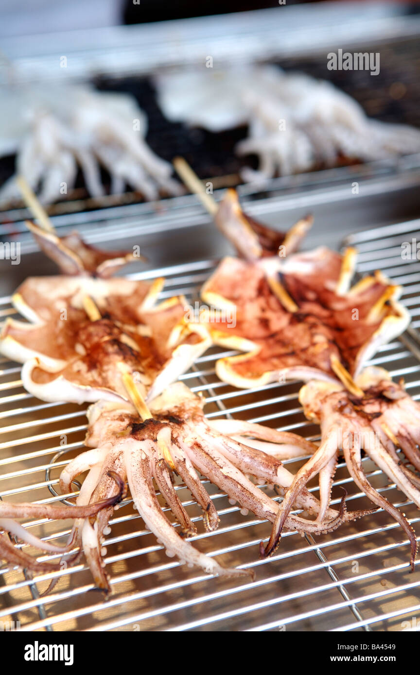 Roasted squid on barbecue close up Stock Photo - Alamy