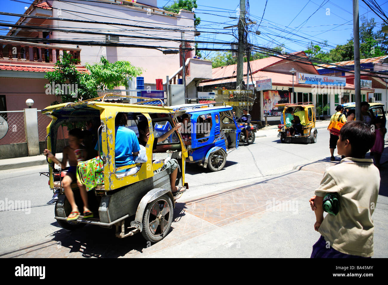 The motorcycle carrying people running on the road Stock Photo - Alamy