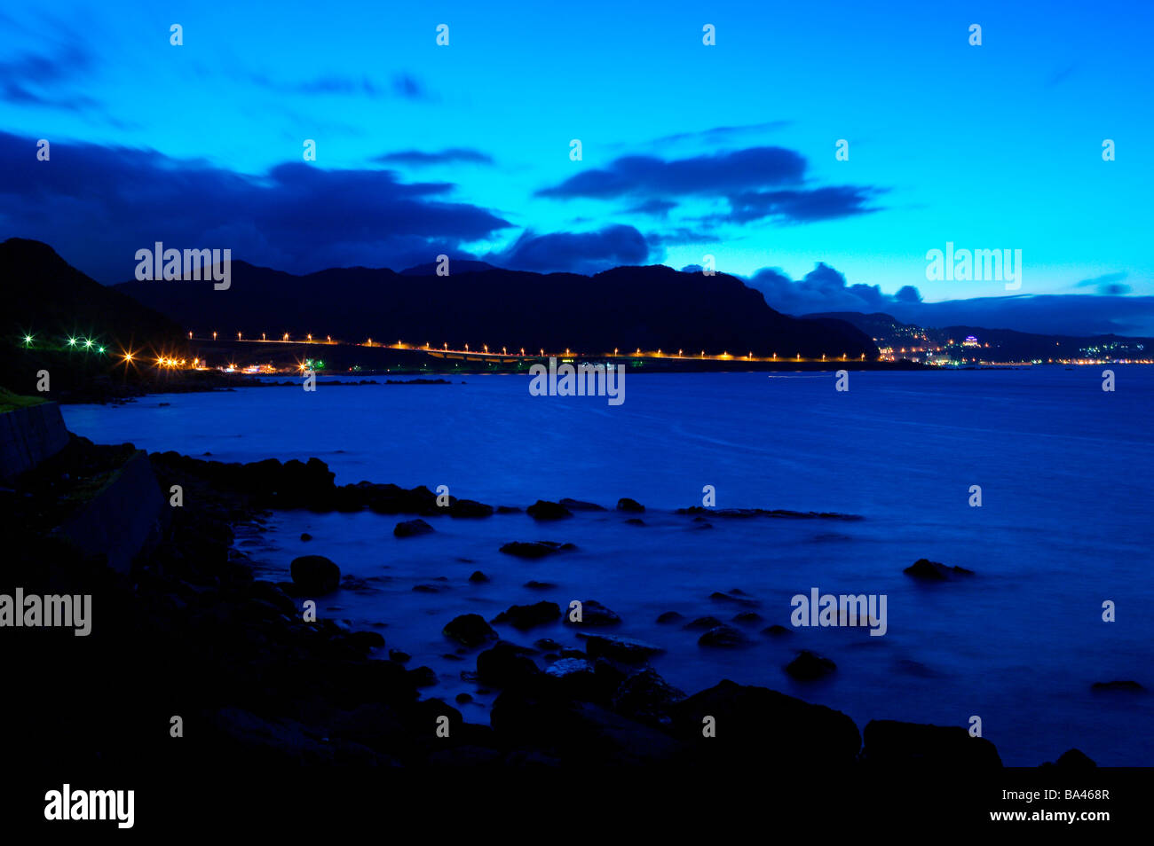 Rocky coast at night Stock Photo - Alamy