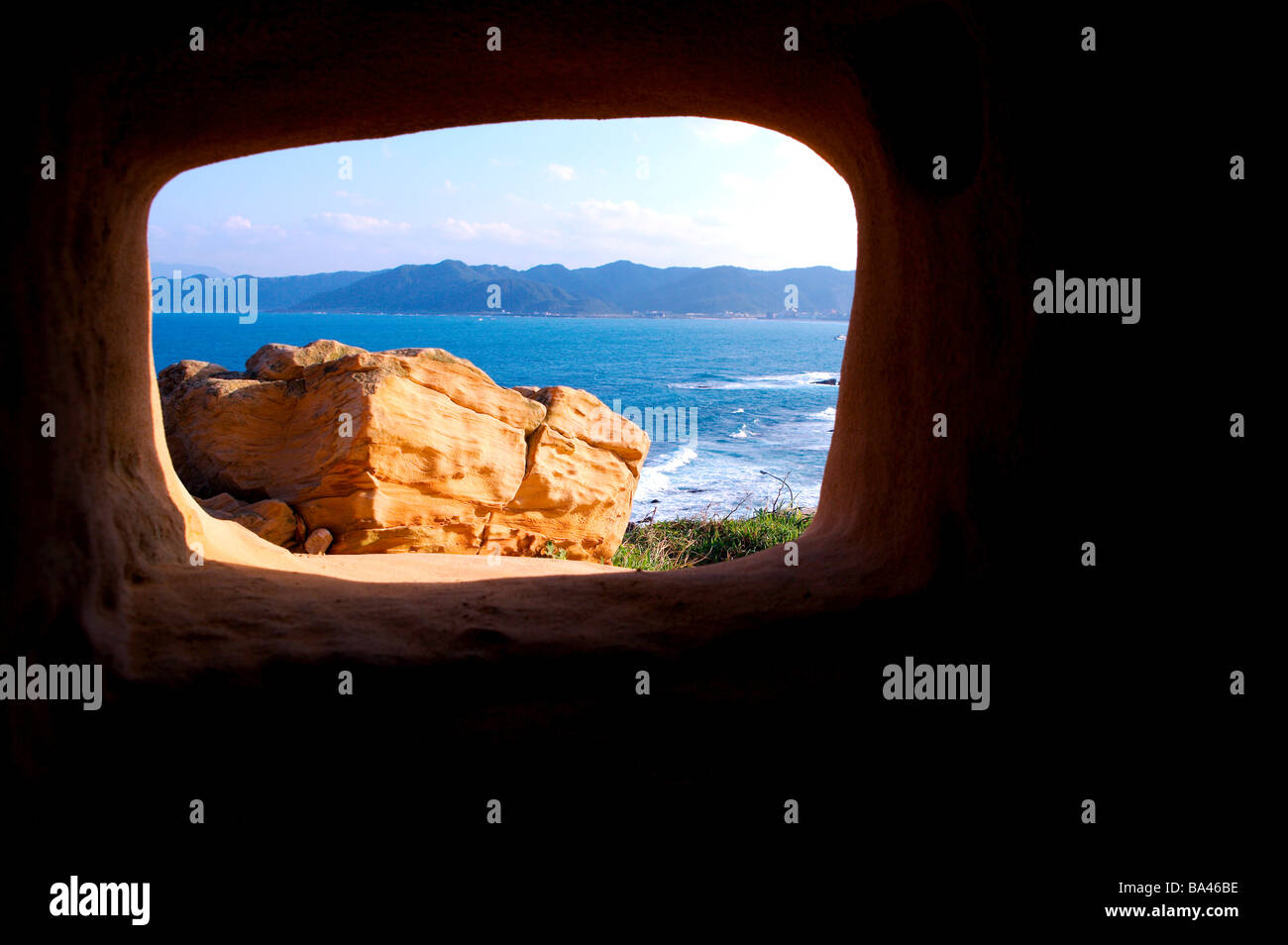 Beach scene from hole of a rock Stock Photo - Alamy