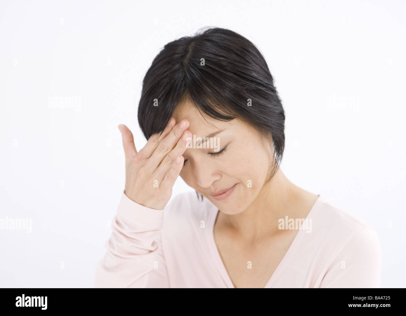 A woman touching her forehead Stock Photo - Alamy A woman touching her forehead Stock Photo - Alamy