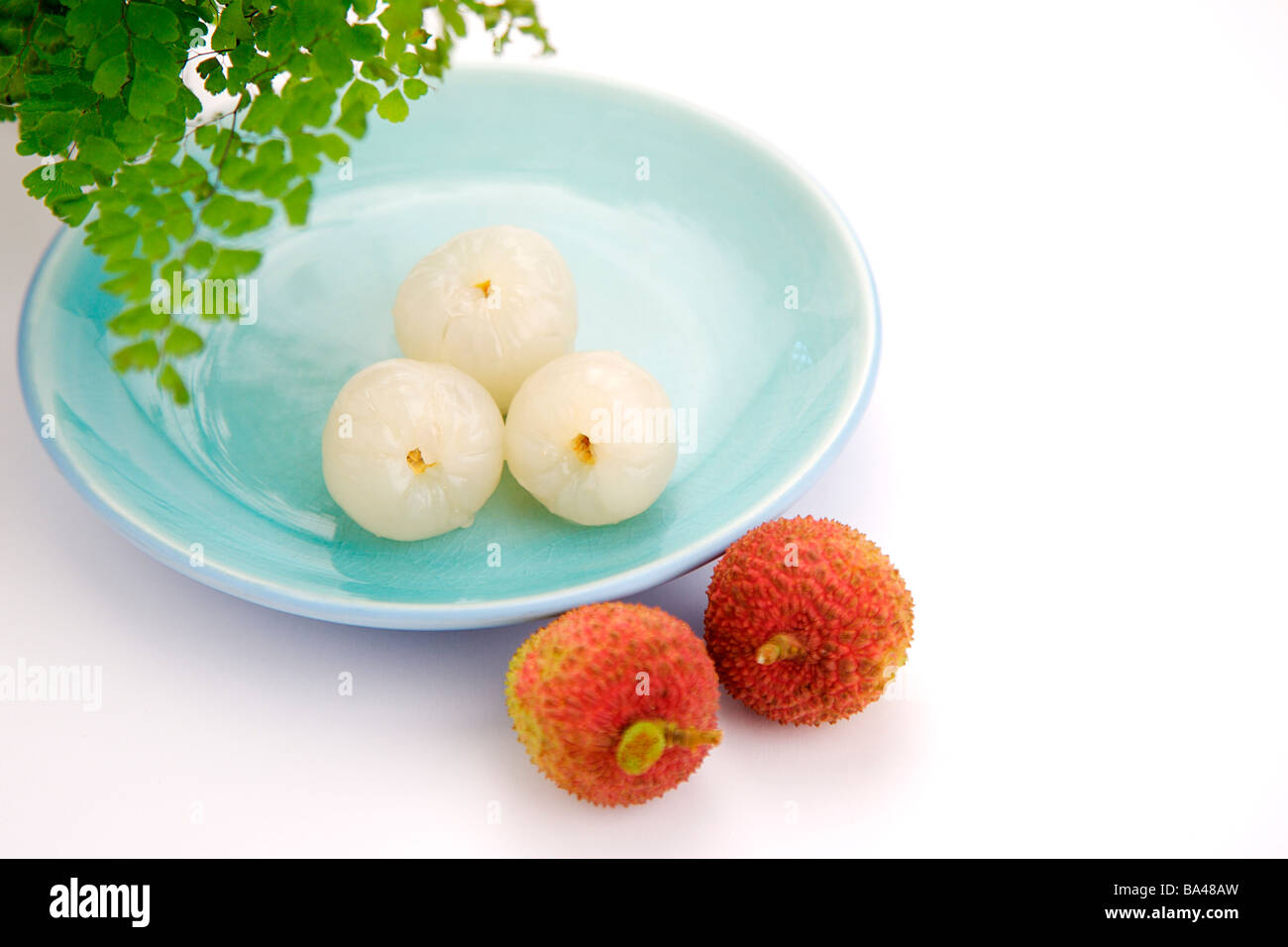 Lychees on and beside ceramic plate Stock Photo - Alamy