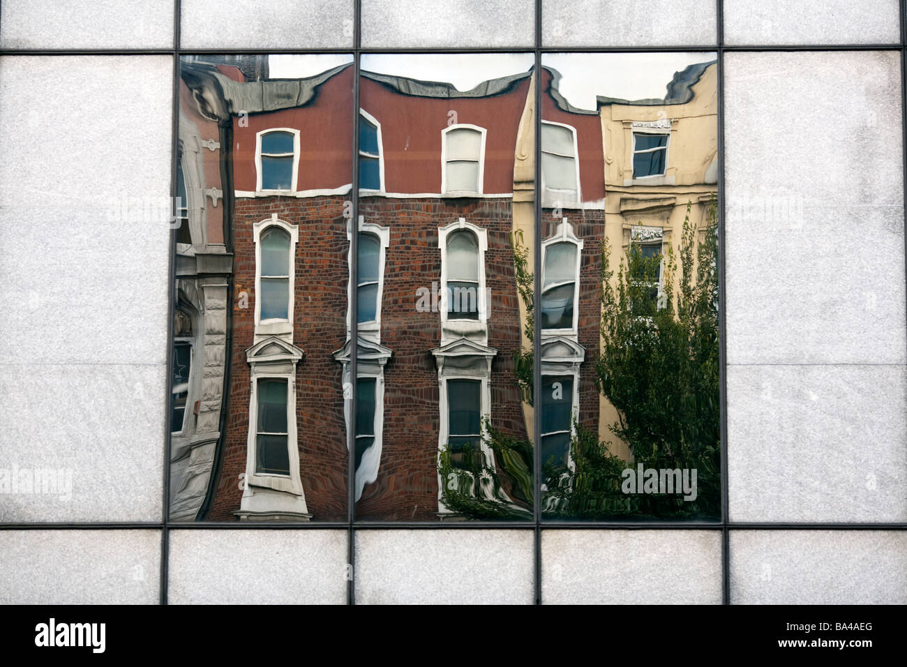 Traditional houses reflected on a modern glass building Dublin Ireland ...