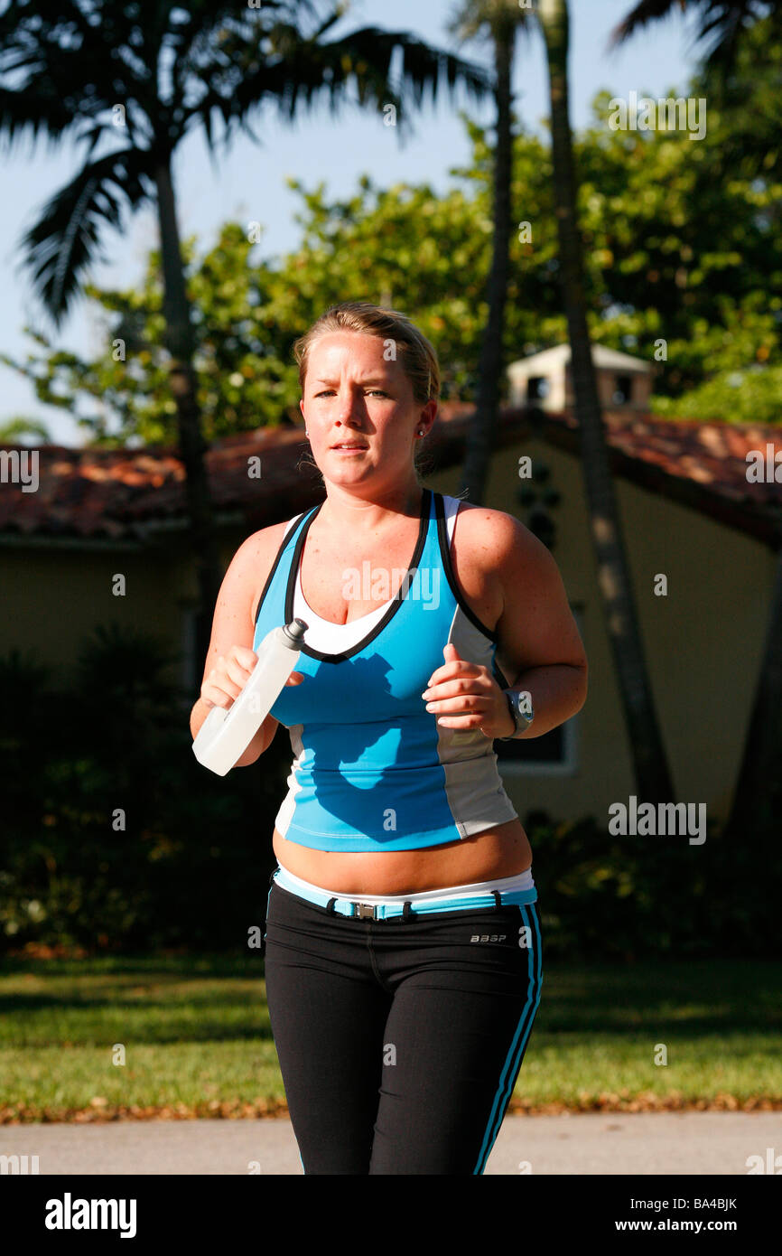 young runner running through neighborhood Stock Photo - Alamy