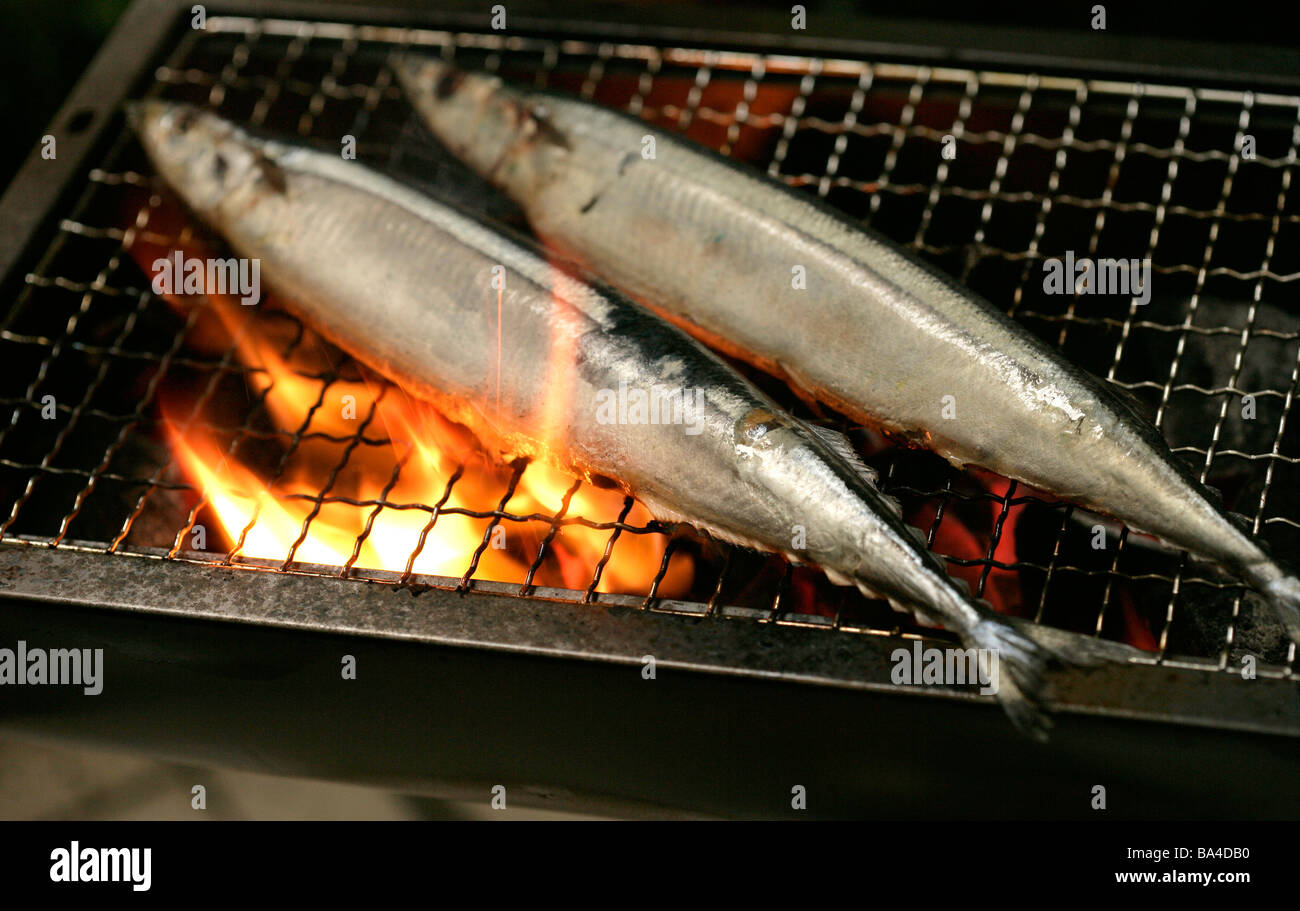 Fish over charcoal fire Stock Photo - Alamy