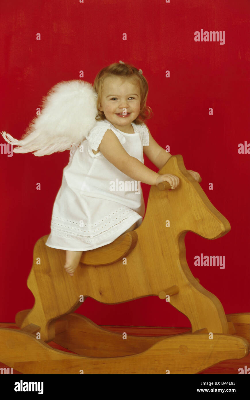 Toddler angel-wings rocking horse laughs people 2 years child girls ...