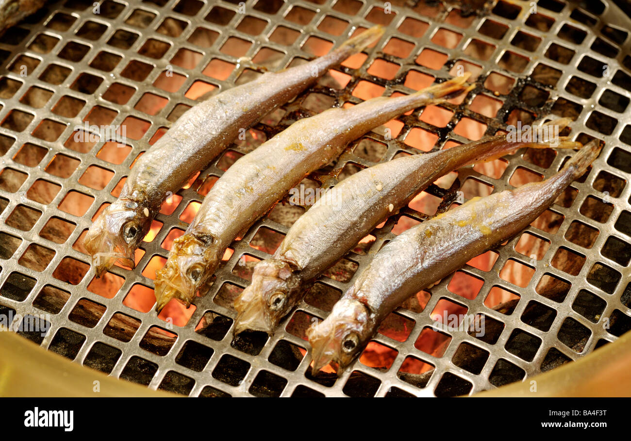 Grilled fish over charcoal fire Stock Photo - Alamy