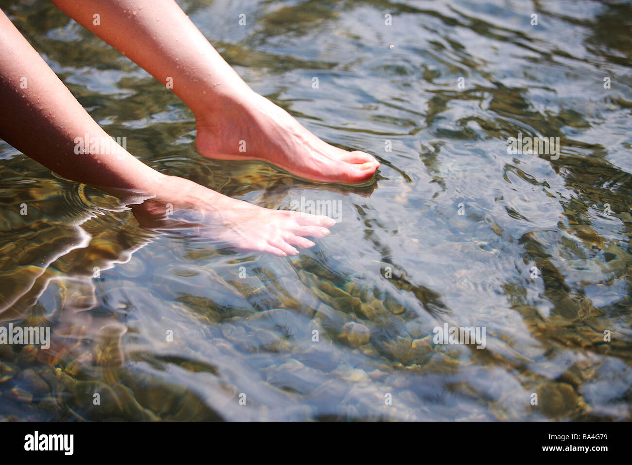 woman s feet in water close up Stock Photo - Alamy