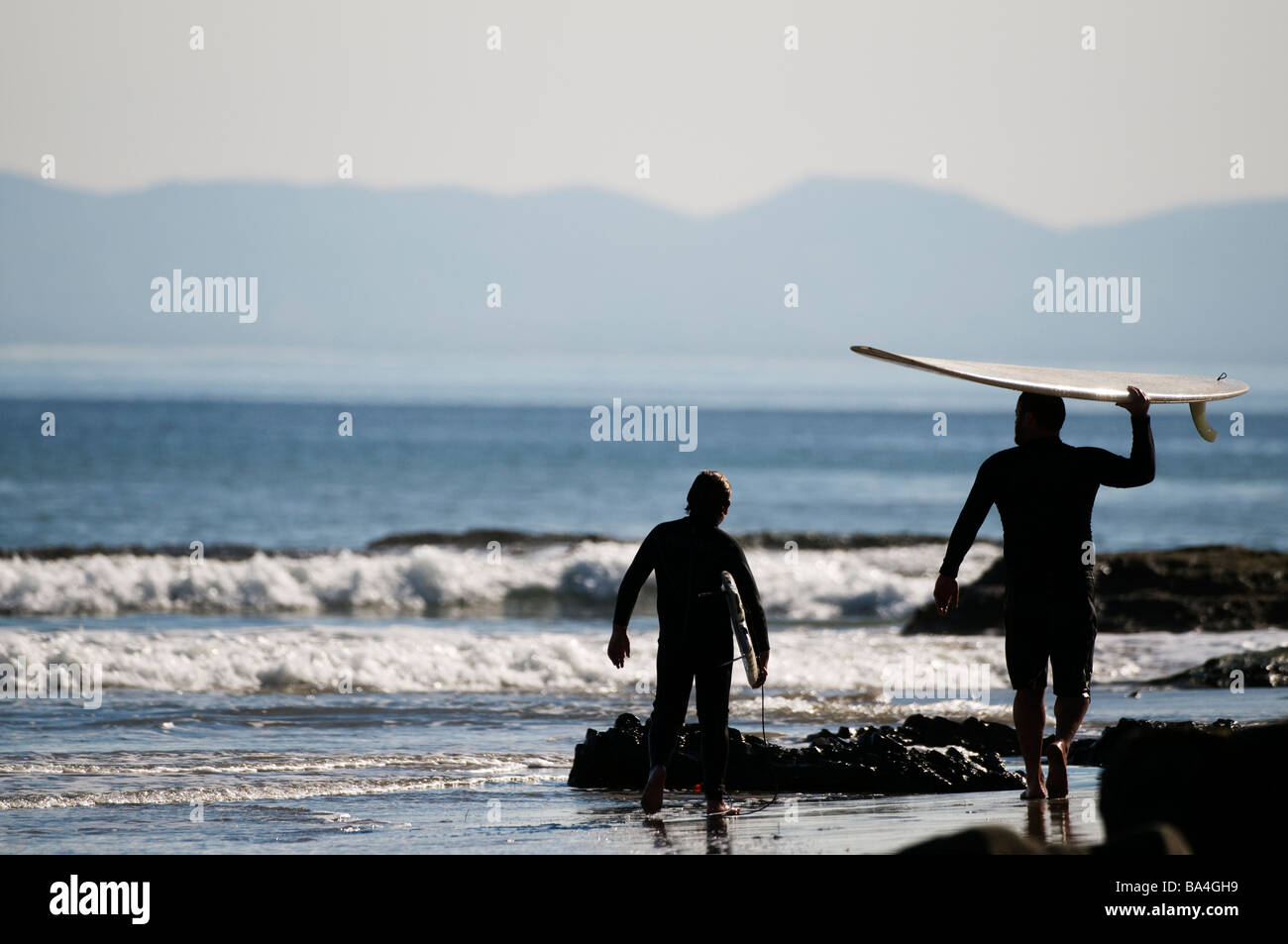 Father and Son Surfers at the beach surfing together Stock Photo - Alamy