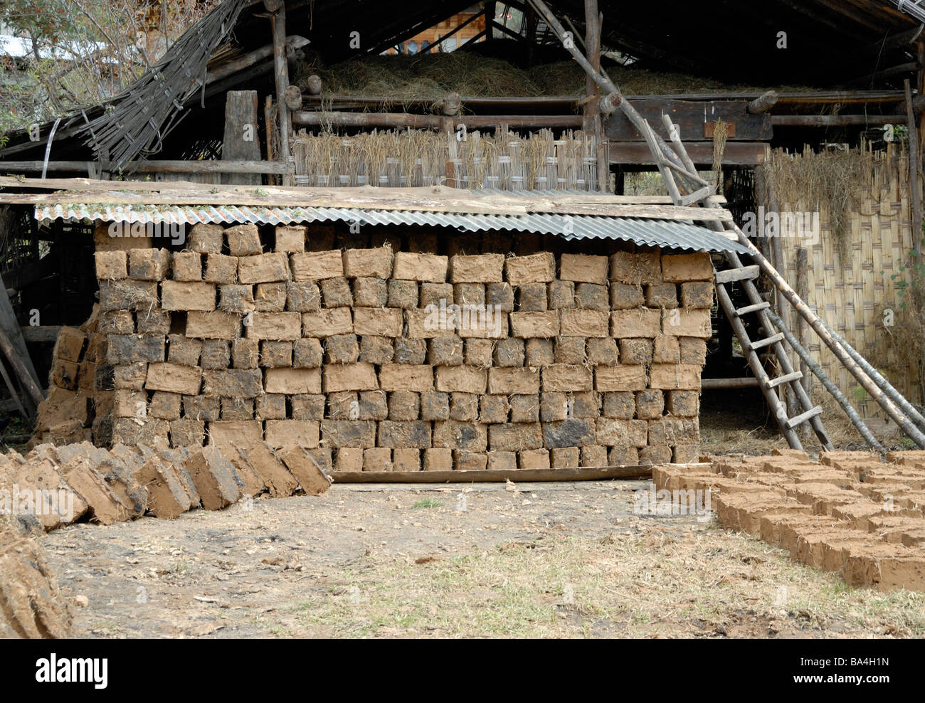 Bricks made from mud and straw lying out to dry Stock Photo - Alamy
