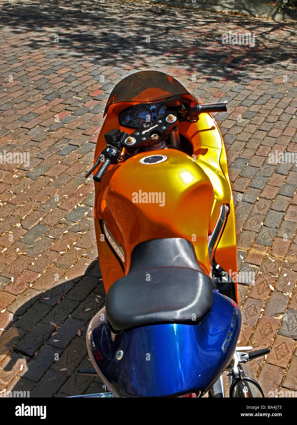 sleek motorcycle viewed from above with blue and orange colors parked ...