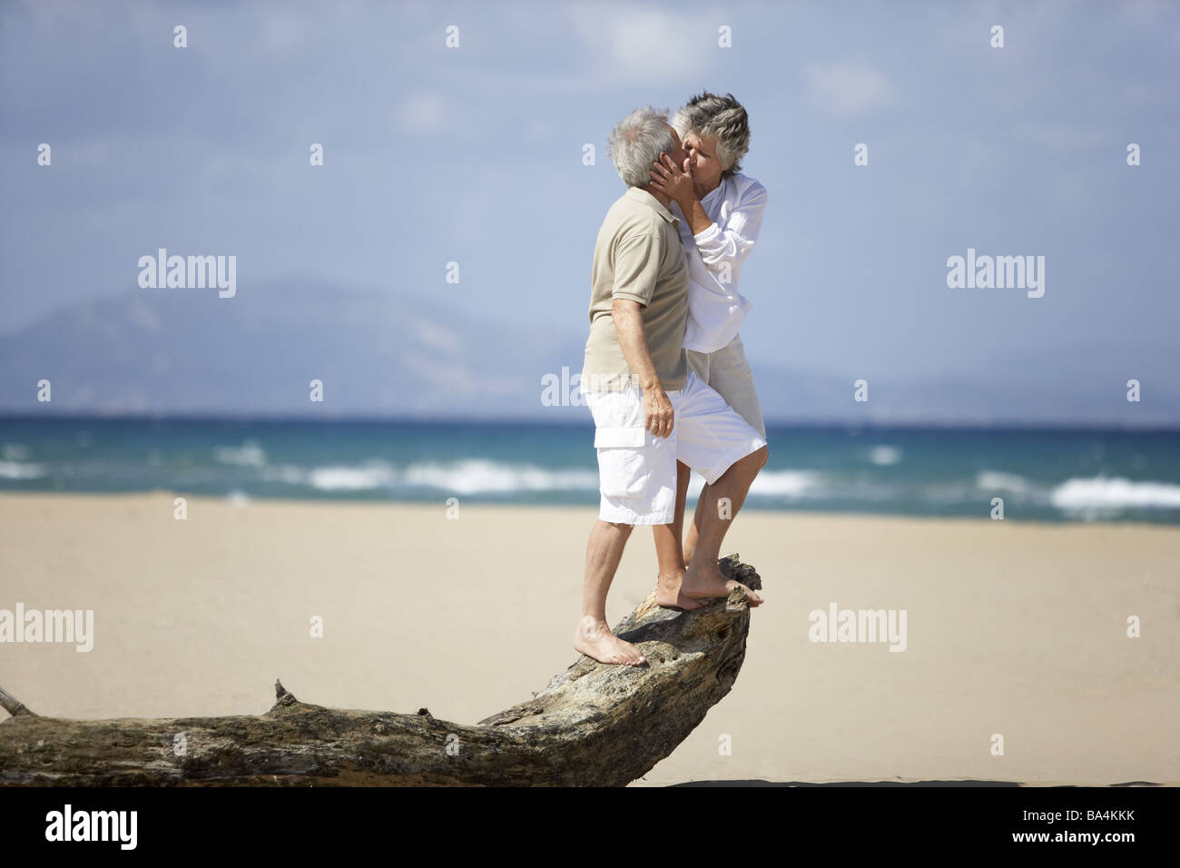 Beach senior-pair log stands embrace kiss series people seniors pair 60 ...