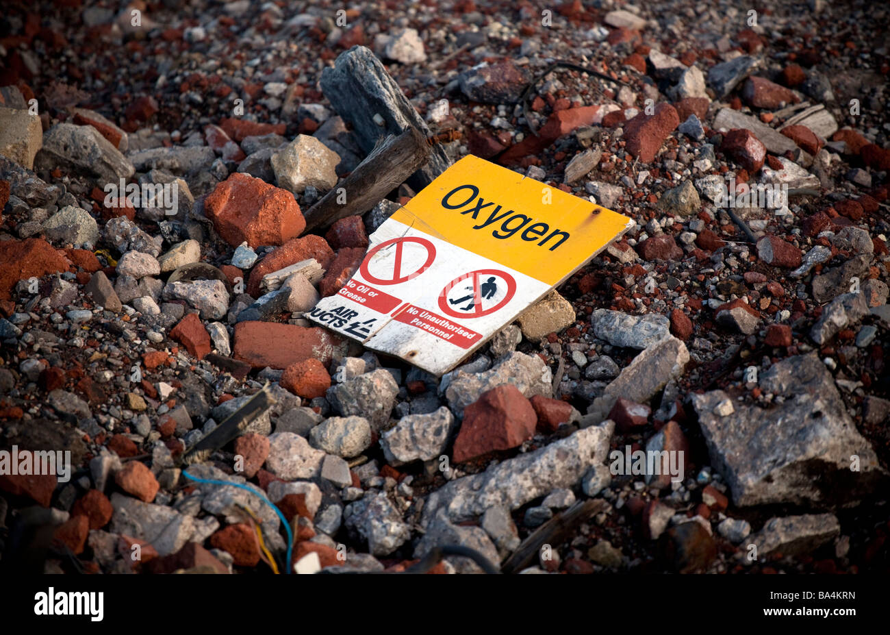 A oxtgen warning sign in building rubble on a disused factory site ...