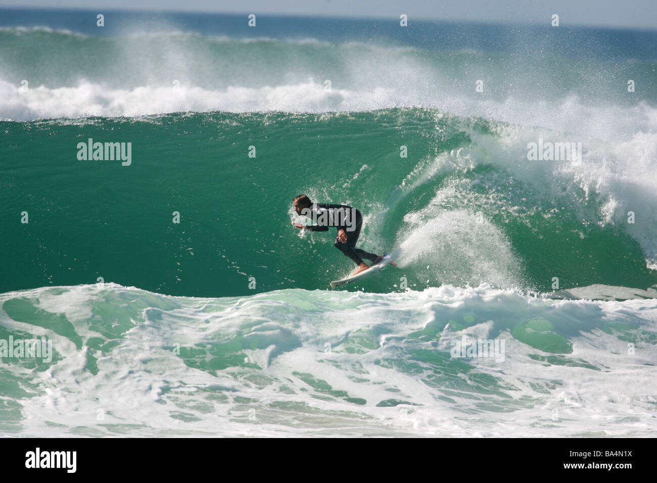 A Surfer rides a wave Stock Photo - Alamy