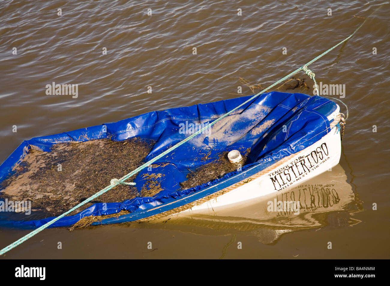 small boat (or tender) sinking showing it's name "mysterioso Stock ...