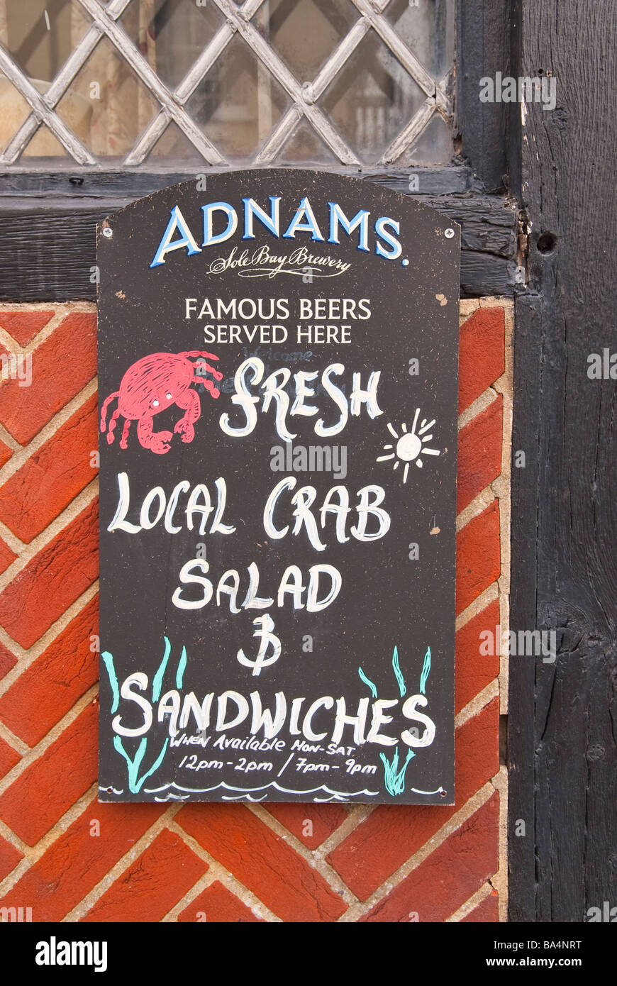 A sign outside a pub advertising adnams beers and local crabs on the ...
